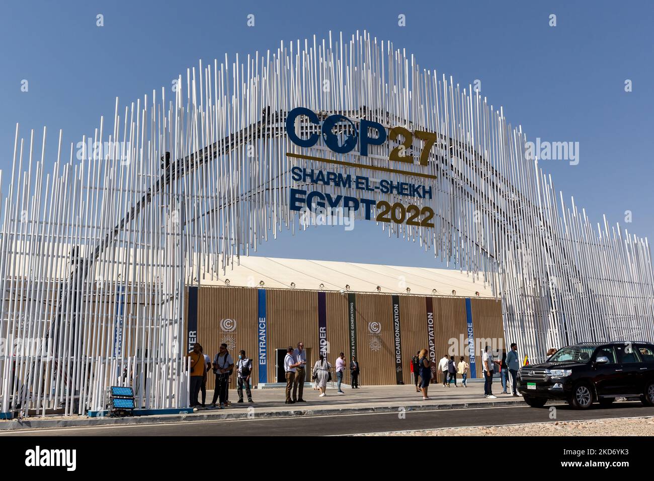 People gather at the main entrance as first participants arrive at the ...