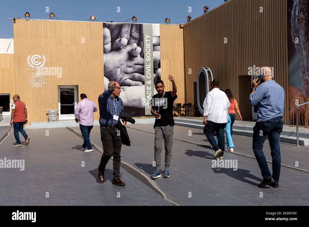 People gather in front of pavilions as first participants arrive at the ...