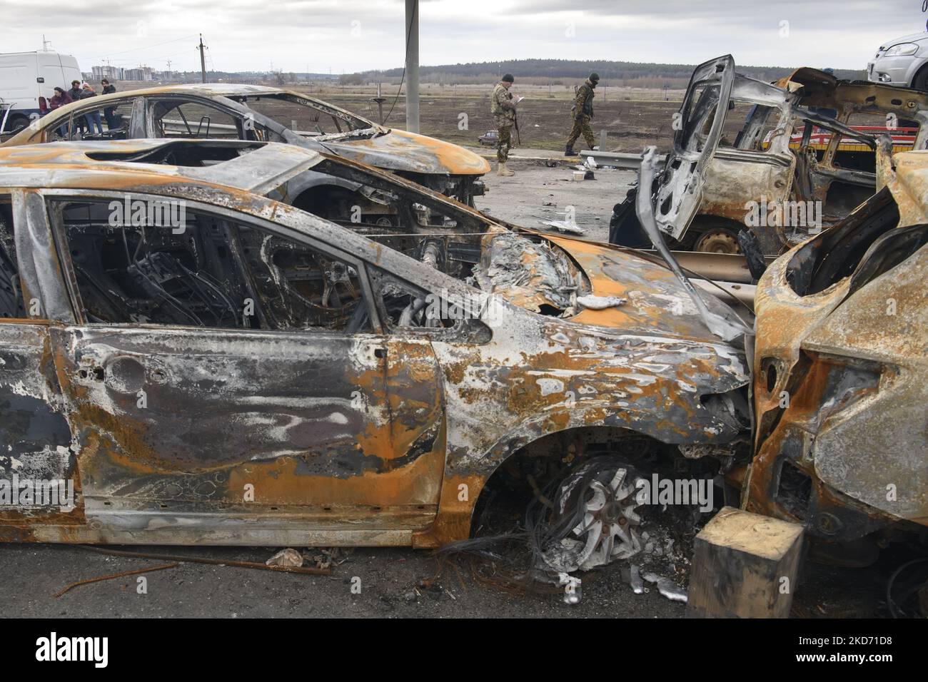 Burnt cars on a destroyed bridge near the recaptured by Ukrainian ...