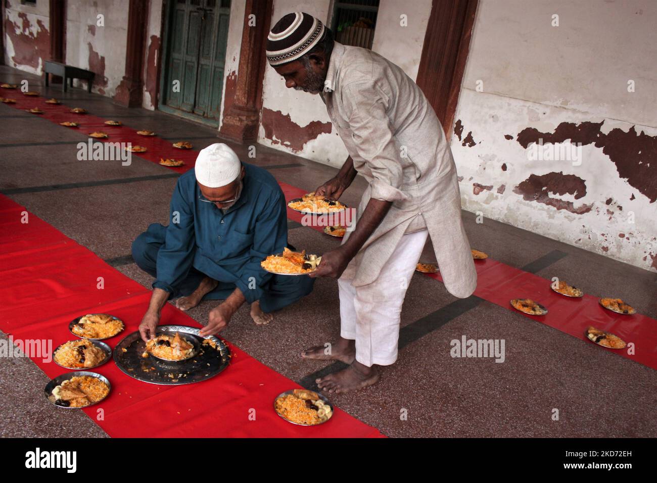 Muslim men arrange plates with snacks to be distributed to break the ...