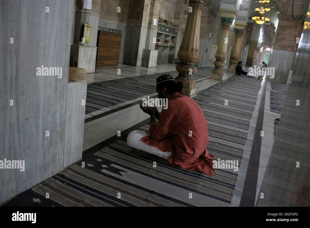 A Muslim man offers prayers before breaking the fast (iftar) during the ...