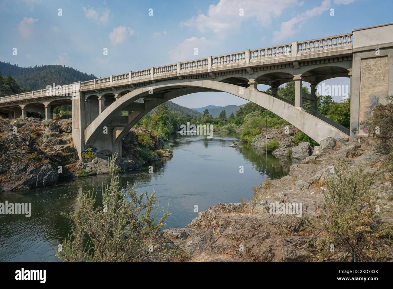 The arched Rock Point Bridge crosses a swimming hole along the Rogue ...