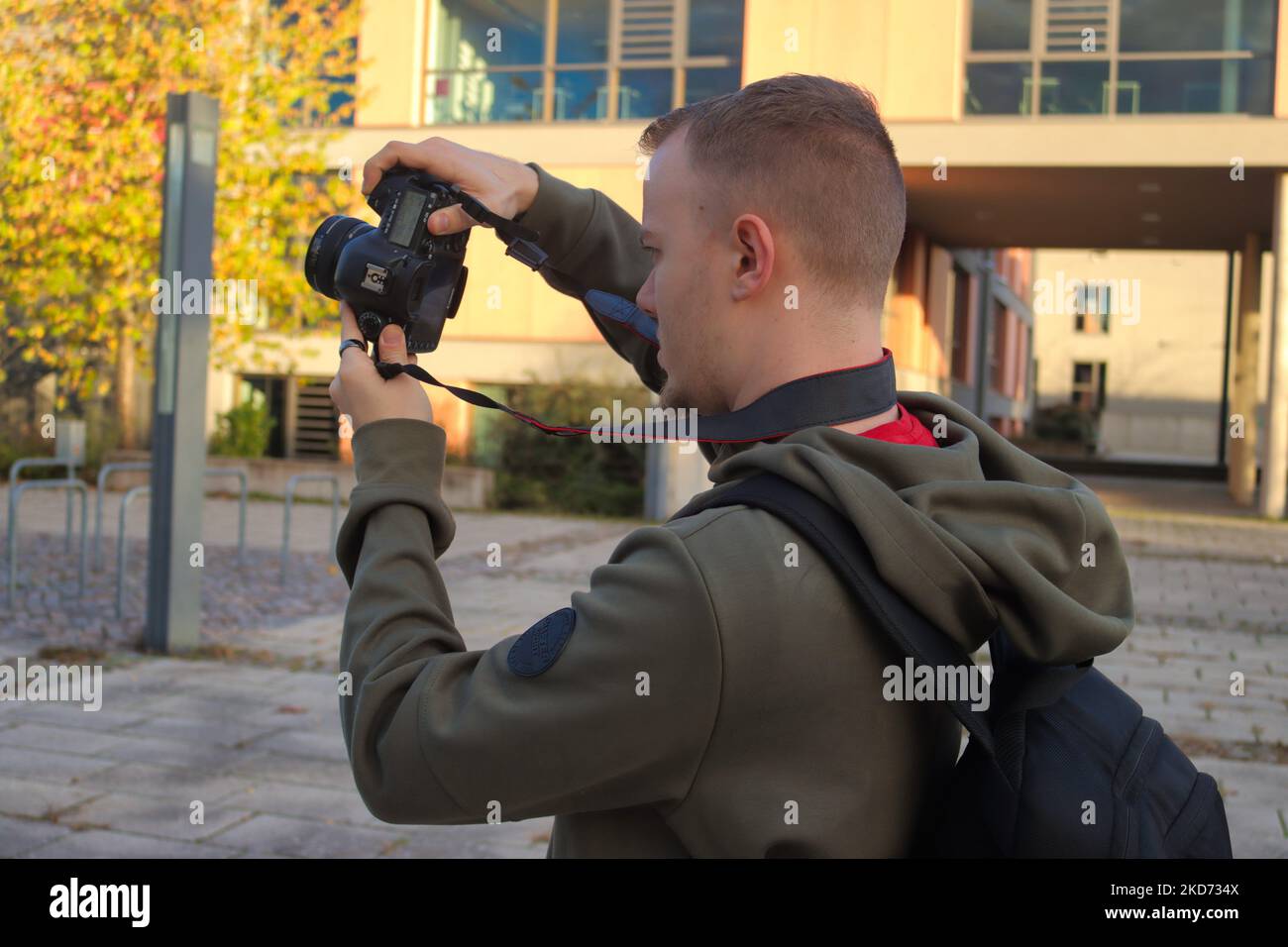 The portrait of a man taking photos with his camera Stock Photo - Alamy
