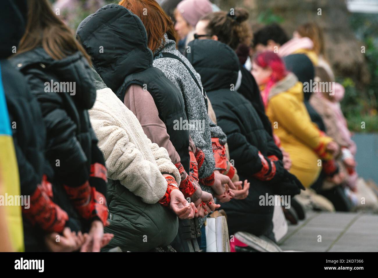 protesters are seen with hands tied behind her back during the protest ...