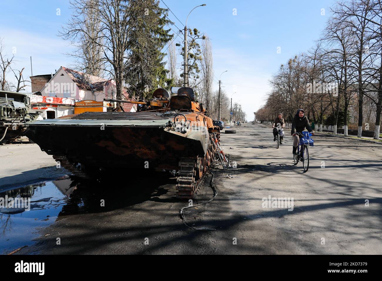 Cyclists are seen on the messy streets in Borodyanka , Bucha Raion of ...