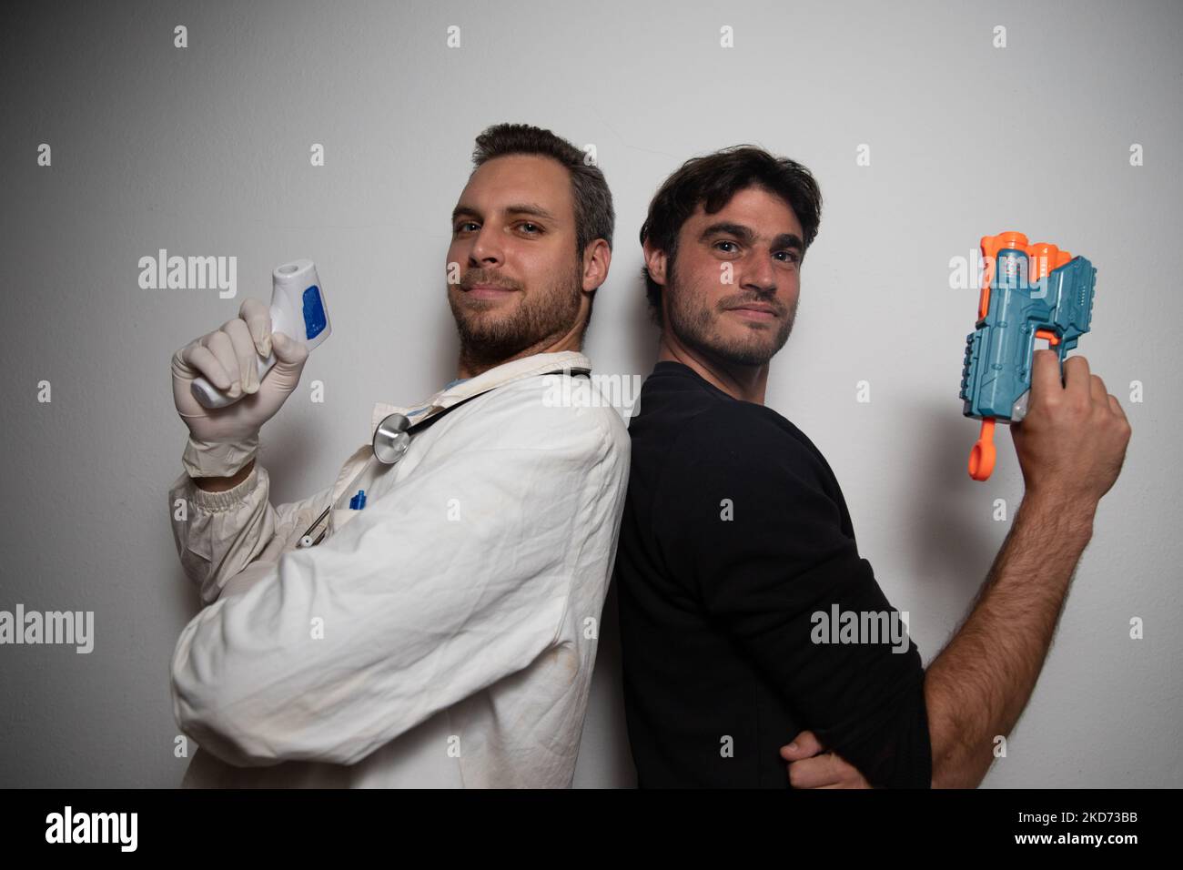 Doctor and patient play, doctor with the gun thermometer and the ...