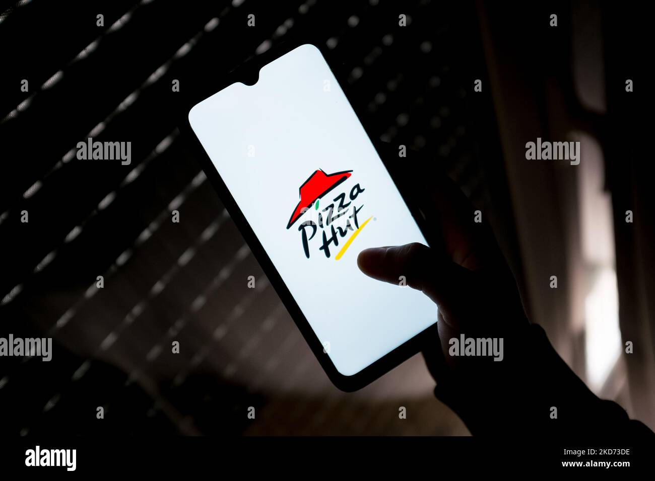 In this photo illustration a Pizza Hut logo seen displayed on a ...