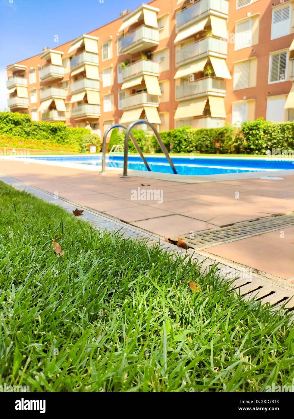Private neighborhood community swimming pool in summer. With grass and ...