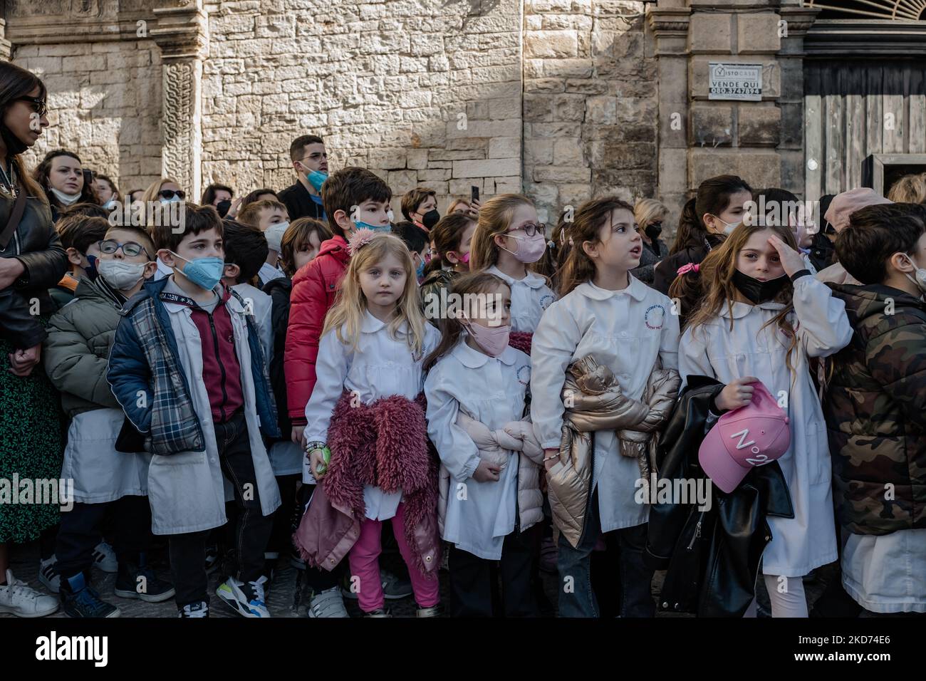 Children observe the procession of the Desolata in front of the Co ...