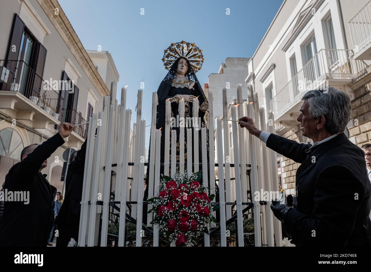 Bearers of the Statue of the Madonna relight the unlit candles during ...