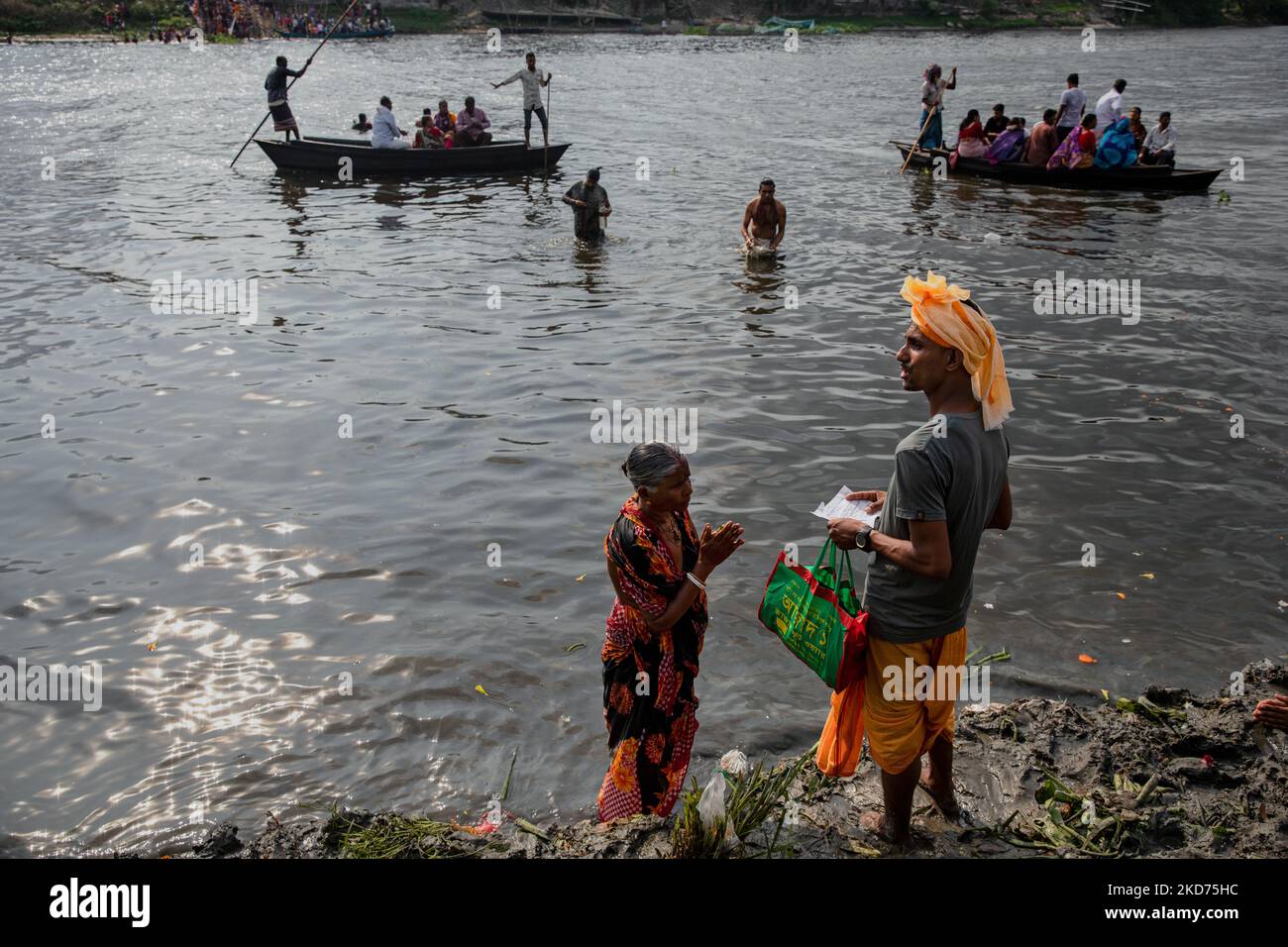 Bangladeshi Hindu devotees take a holy bath and pray in the Brahmputra ...