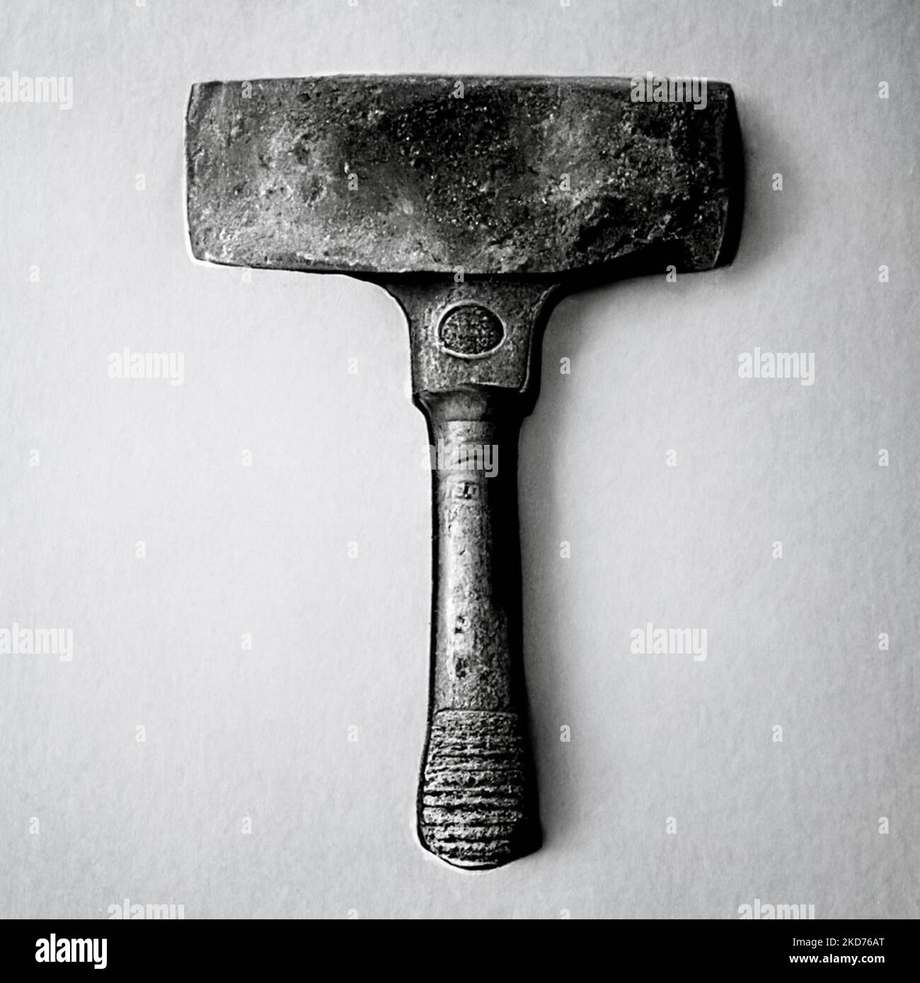 A black steel hammer on a grey background Stock Photo - Alamy