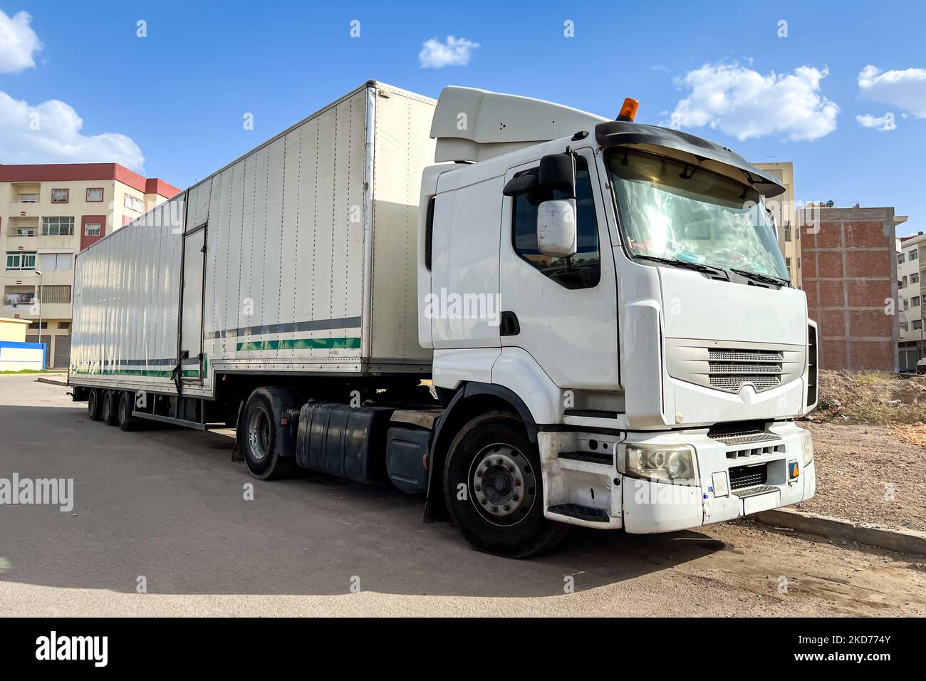 Long white trailer truck parked on the road Stock Photo - Alamy