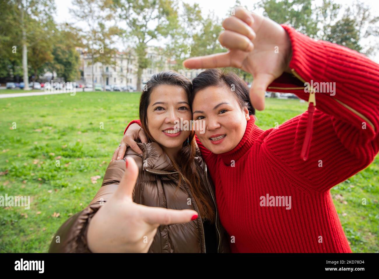 Asian friends enjoying themselves at the public park, togetherness and ...