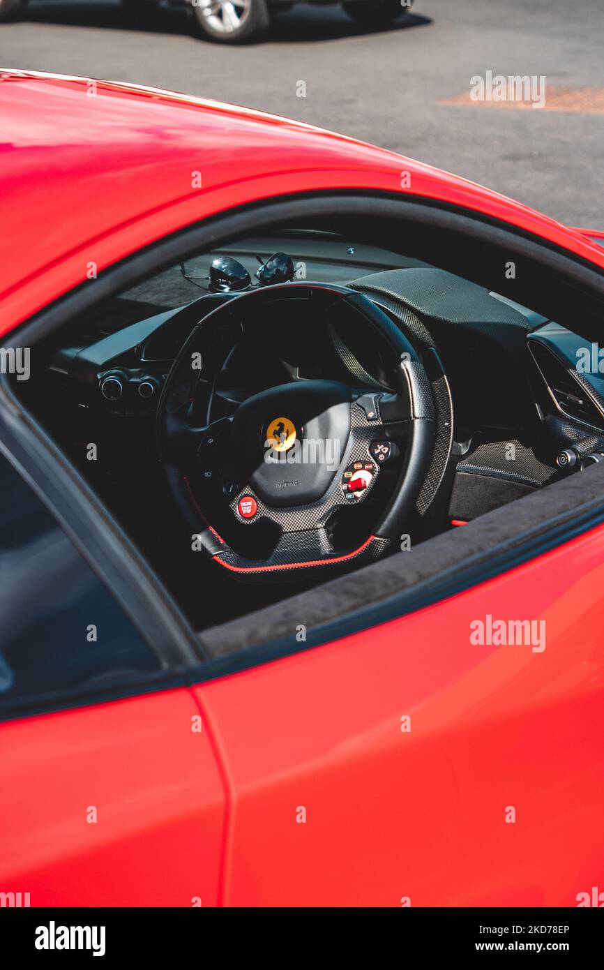 A vertical shot of a red Ferrari 488. Steering wheel Stock Photo - Alamy