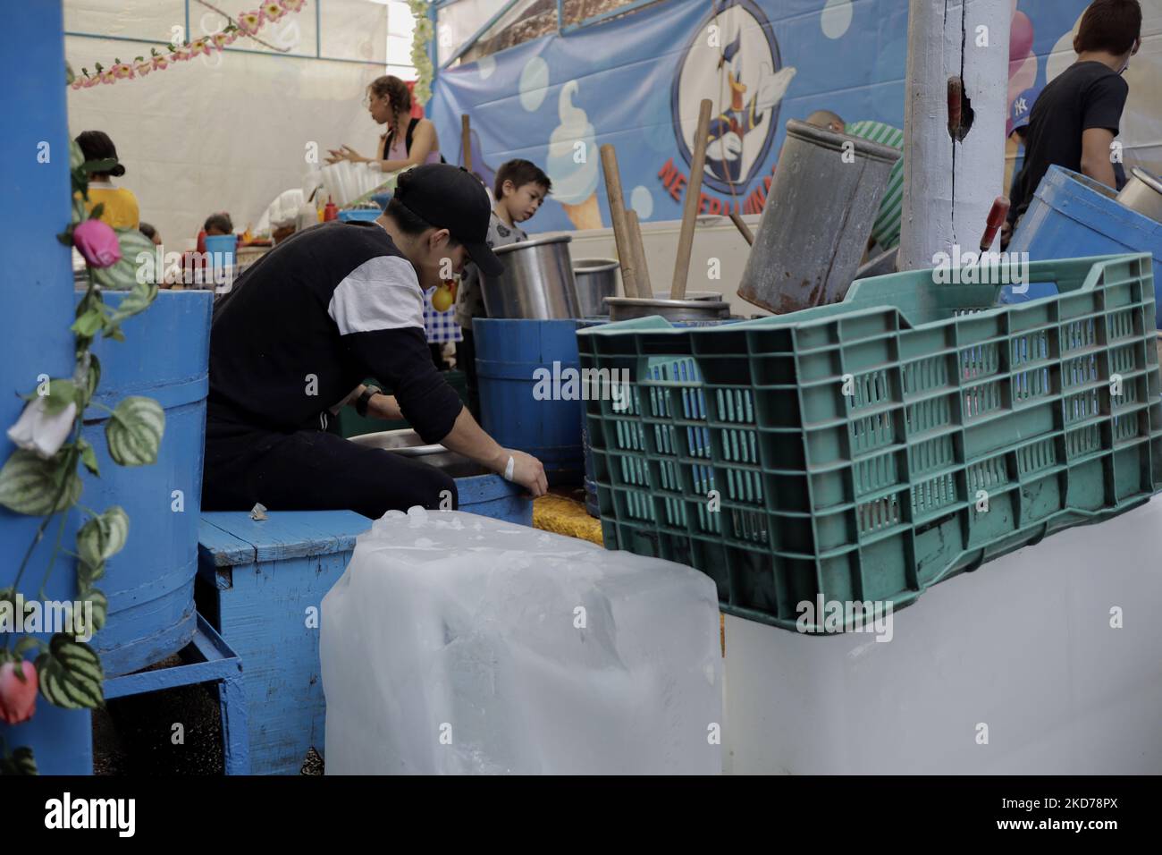 Several people prepare snow during the inauguration of the Snow Fair in ...