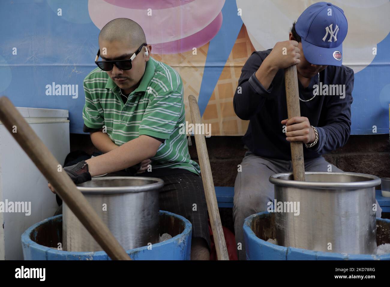 Two people prepare snow during the inauguration of the Snow Fair in ...