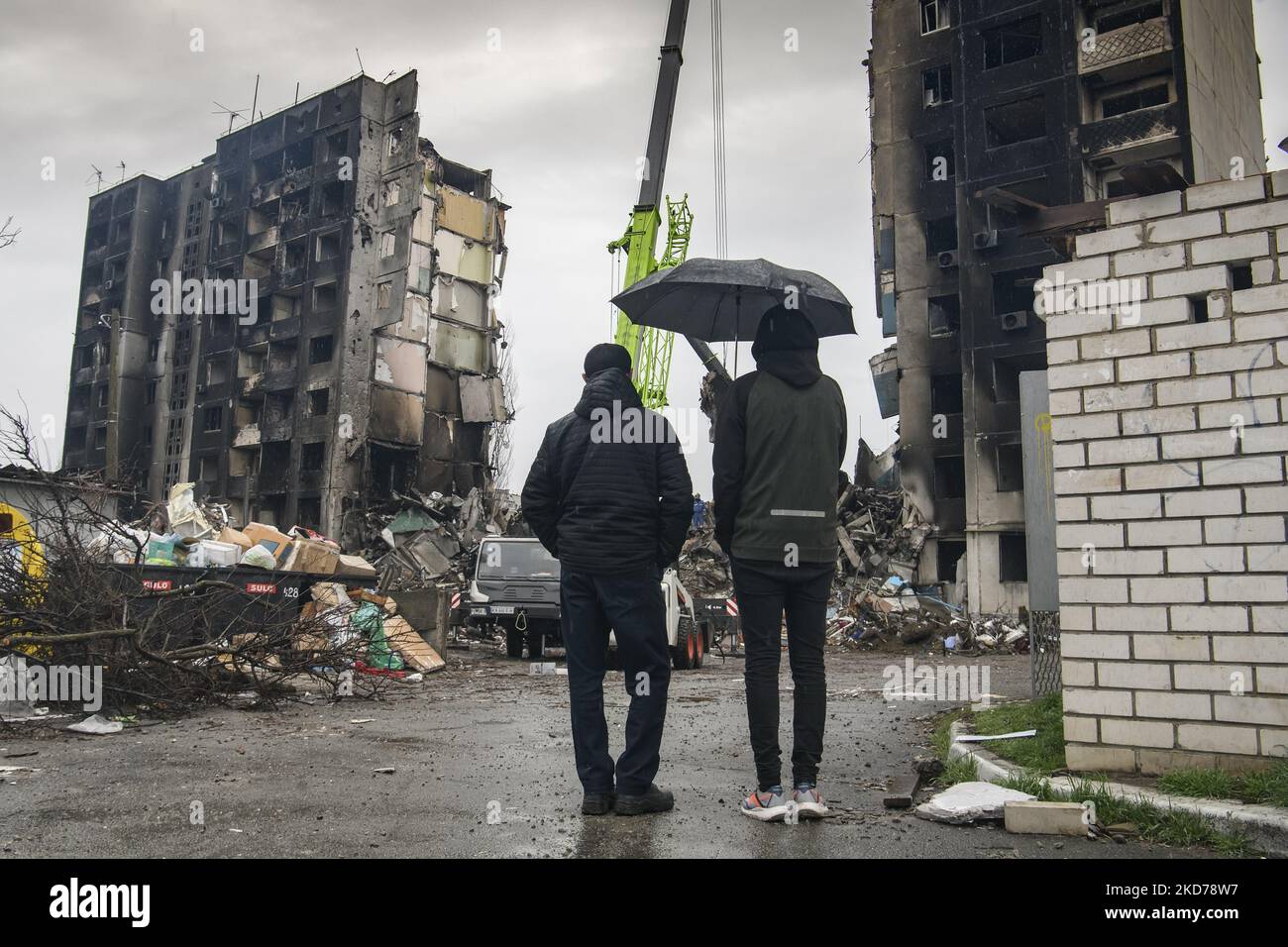 Local residents observed as Ukrainian Rescuers worked to clear the ...