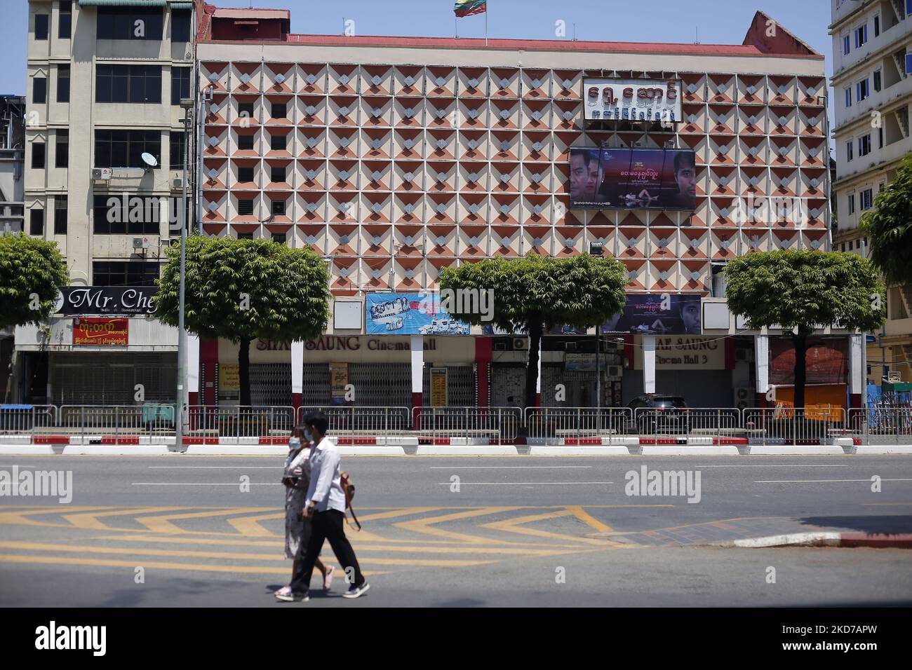 A couple walk pastÂ the Shae Saung Cinema in Yangon, Myanmar on April ...