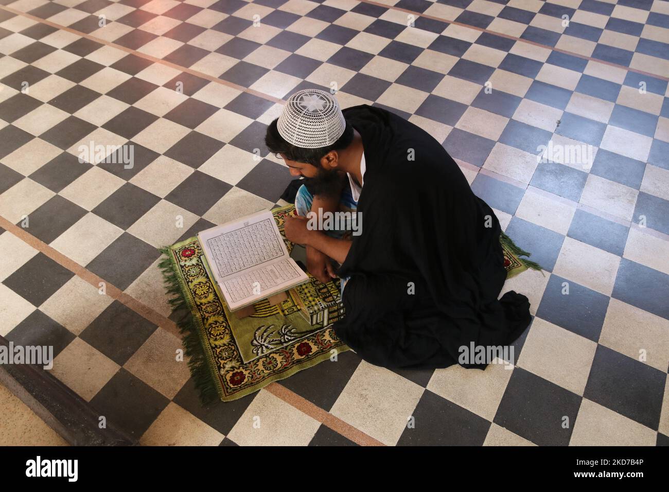 Indian Muslim read from The Quran (Islamic Holy Book) as they sit ...