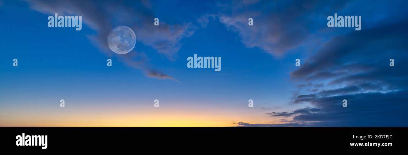 A Detailed Image Of A Full Moon Set Against A Blue Daytime Sky In ...
