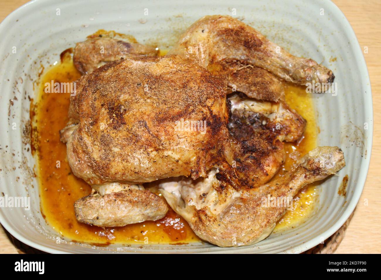 Top down view up whole roast chicken in light blue ceramic dish. Home ...