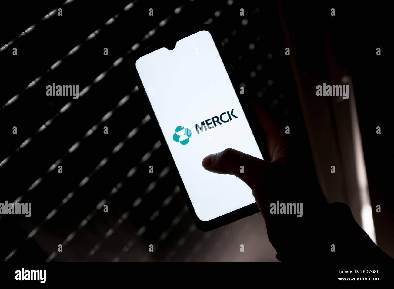 In this photo illustration a Merck logo seen displayed on a smartphone ...