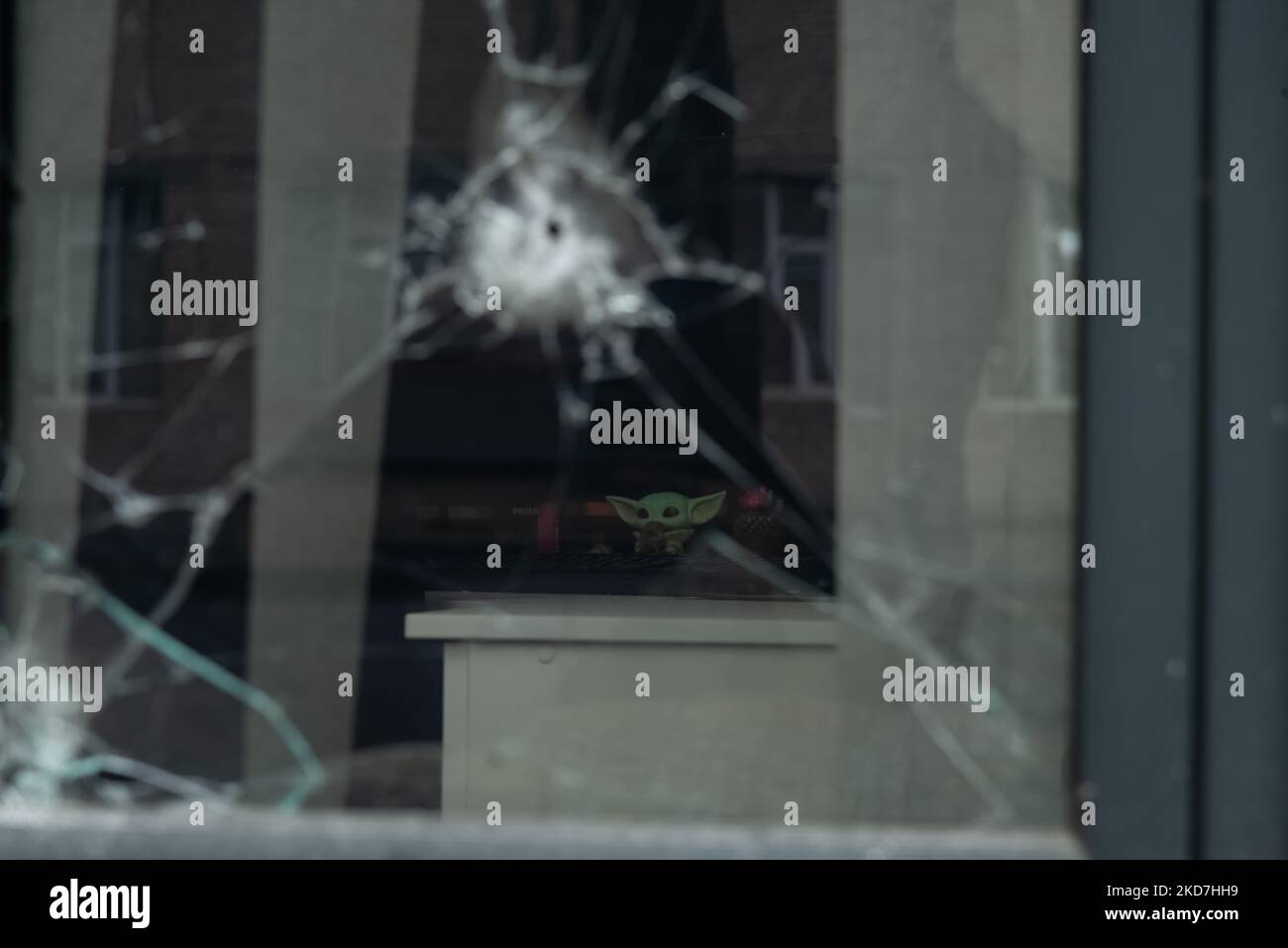 A puppet is seen through a window shot by gunfire, inside an office in ...