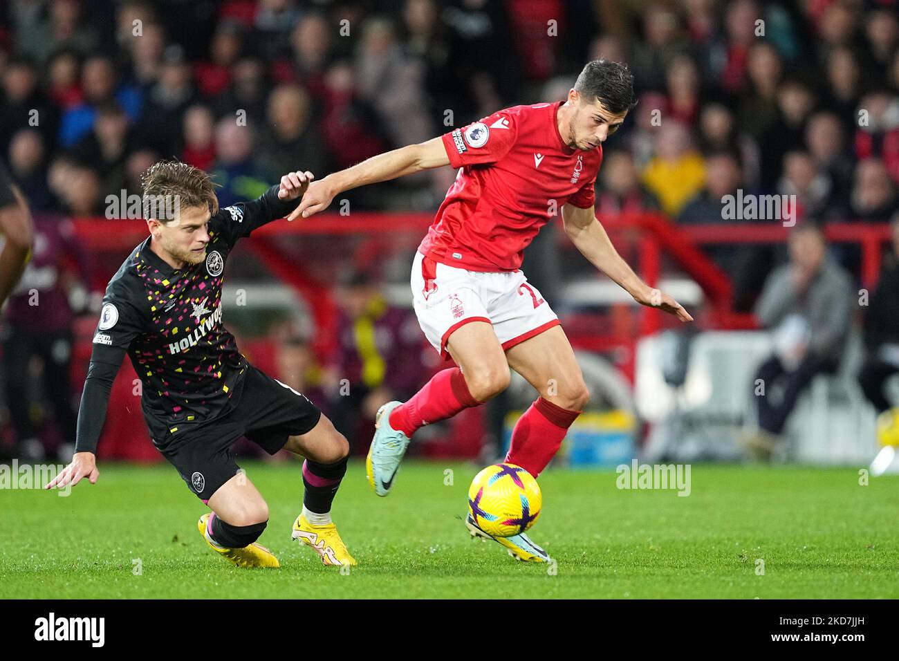 Mathias Jensen of Brentford tries to tackle Remo Freuler of Nottingham ...