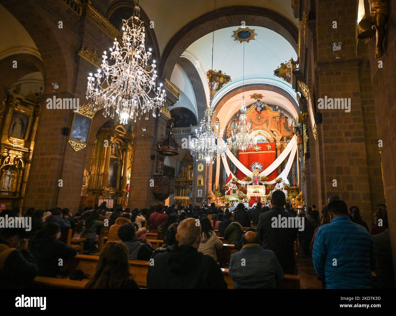 Worshipers inside the Basilica of La Merced. All churches in Cusco are ...