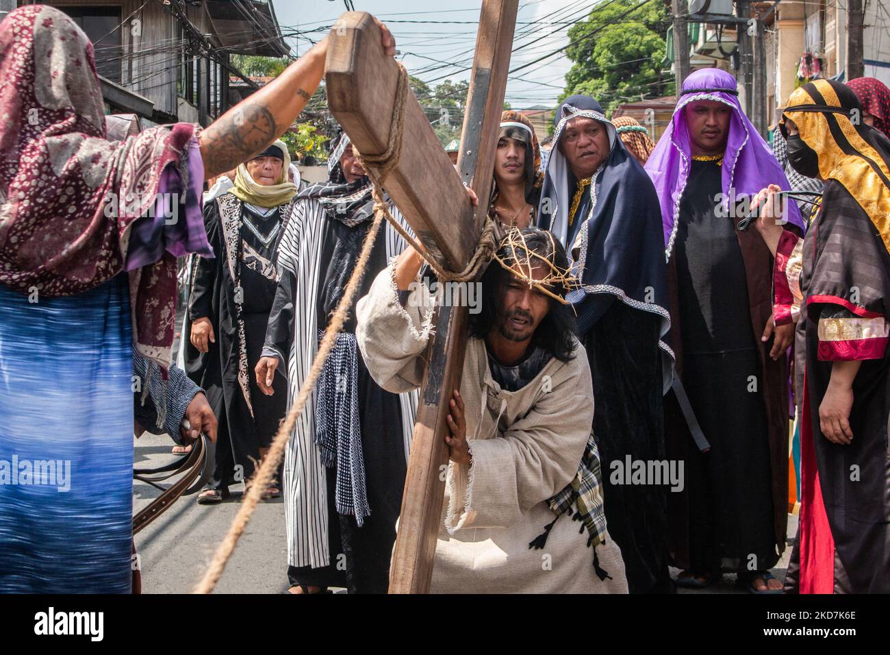 A man reenacts Jesus' carrying the cross on Good Friday in Antipolo ...