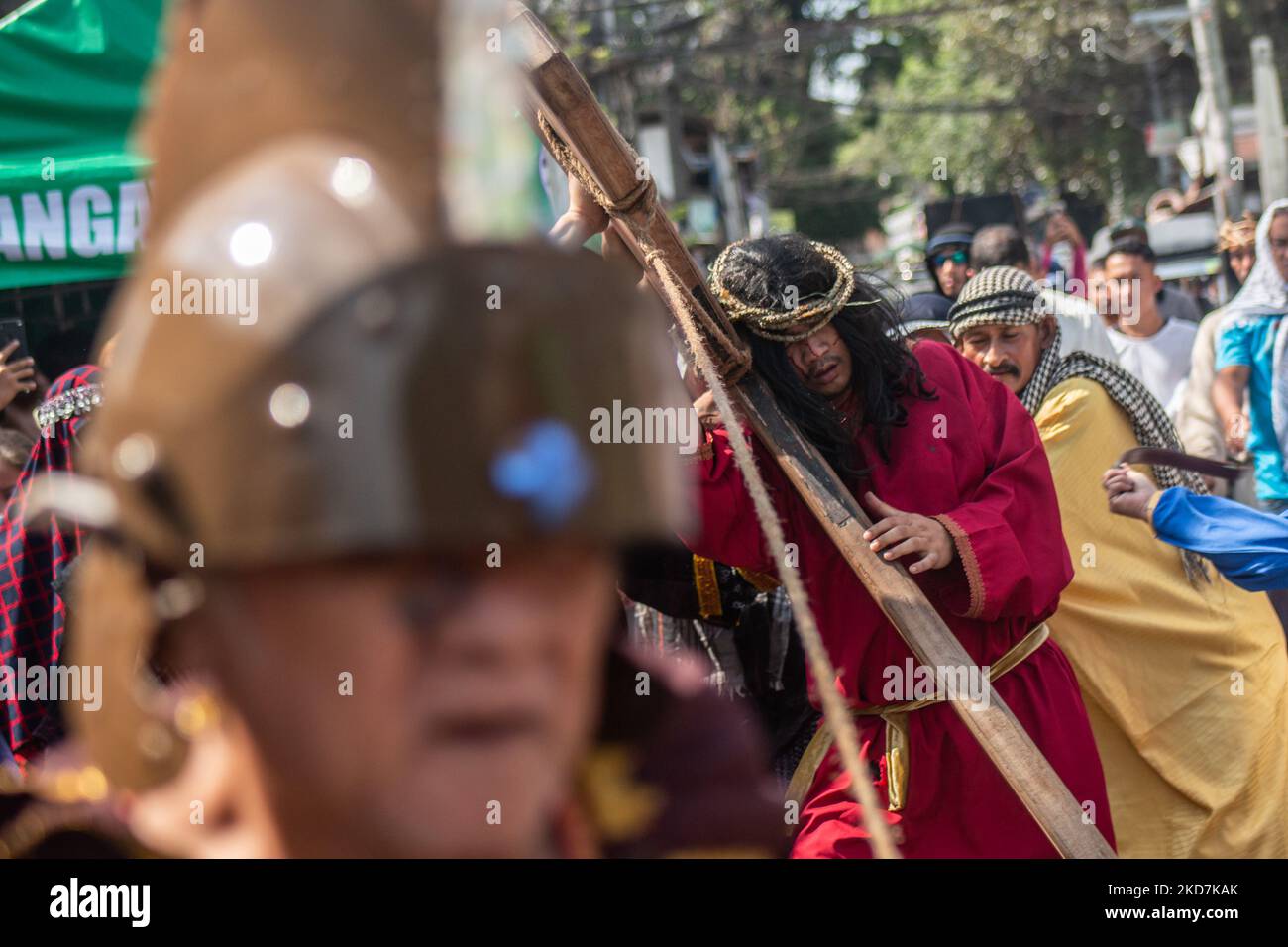 A man reenacts Jesus' carrying the cross on Good Friday in Antipolo ...