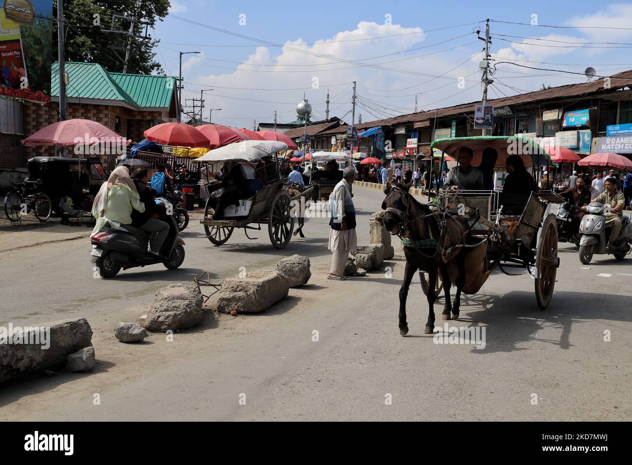 Concrete boulders are kept as road Divider as a Horse carrier moves ...