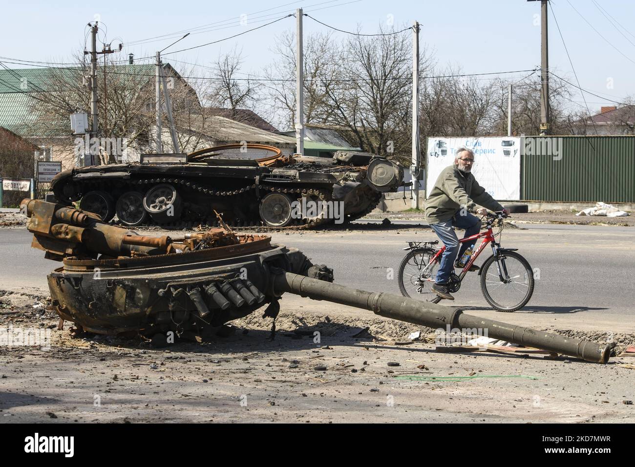 A man ride bike near Destroyed Russian military tank near Brovary, Kyiv ...