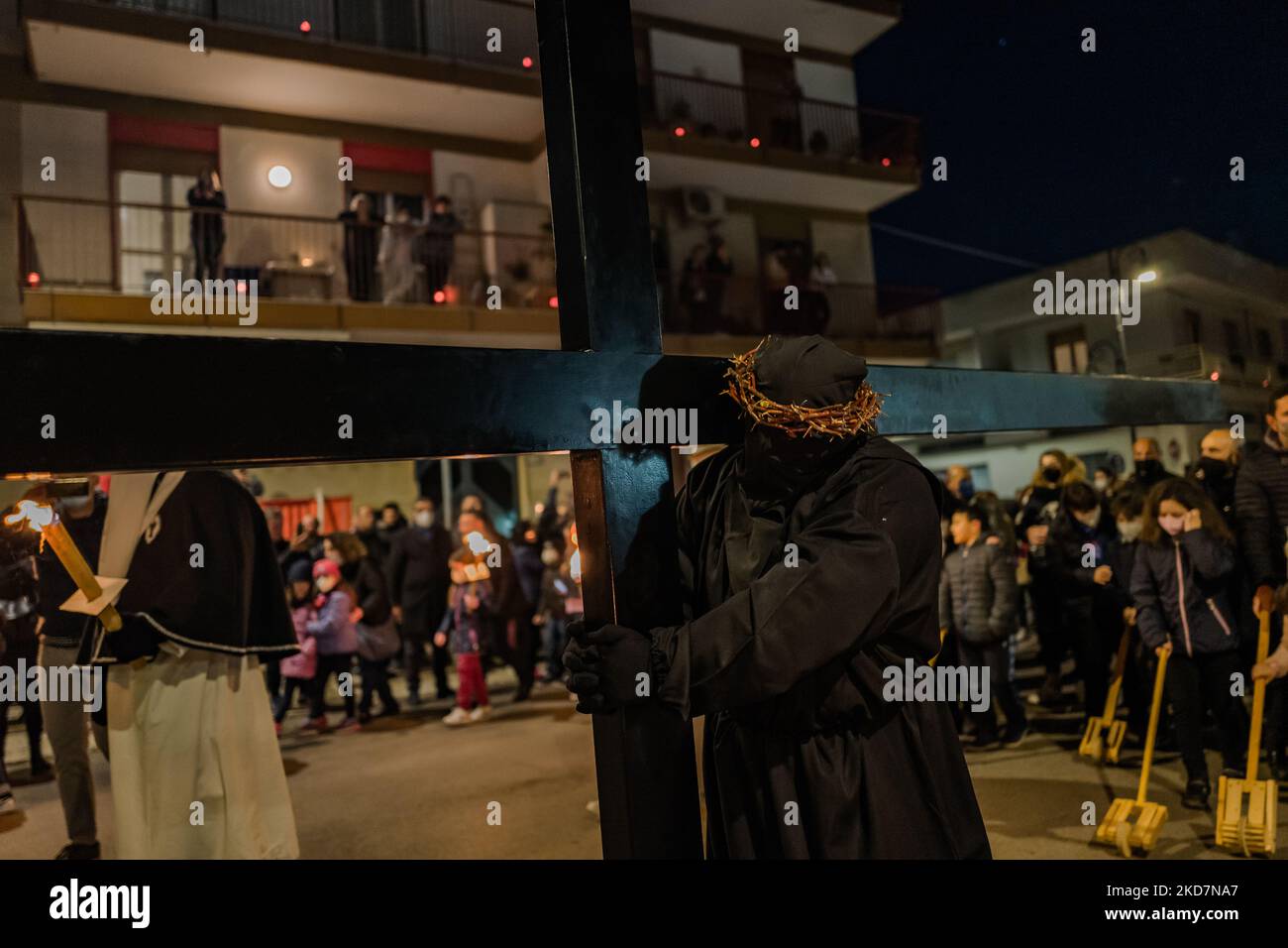 The first crucifer in procession with a heavy cross on his shoulders in ...