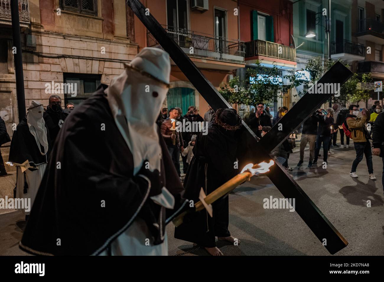 The first crucifer makes a bow at the church before entering to kneel ...
