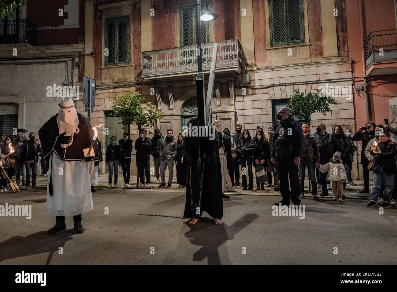 The first crucifer makes a bow at the church before entering to kneel ...