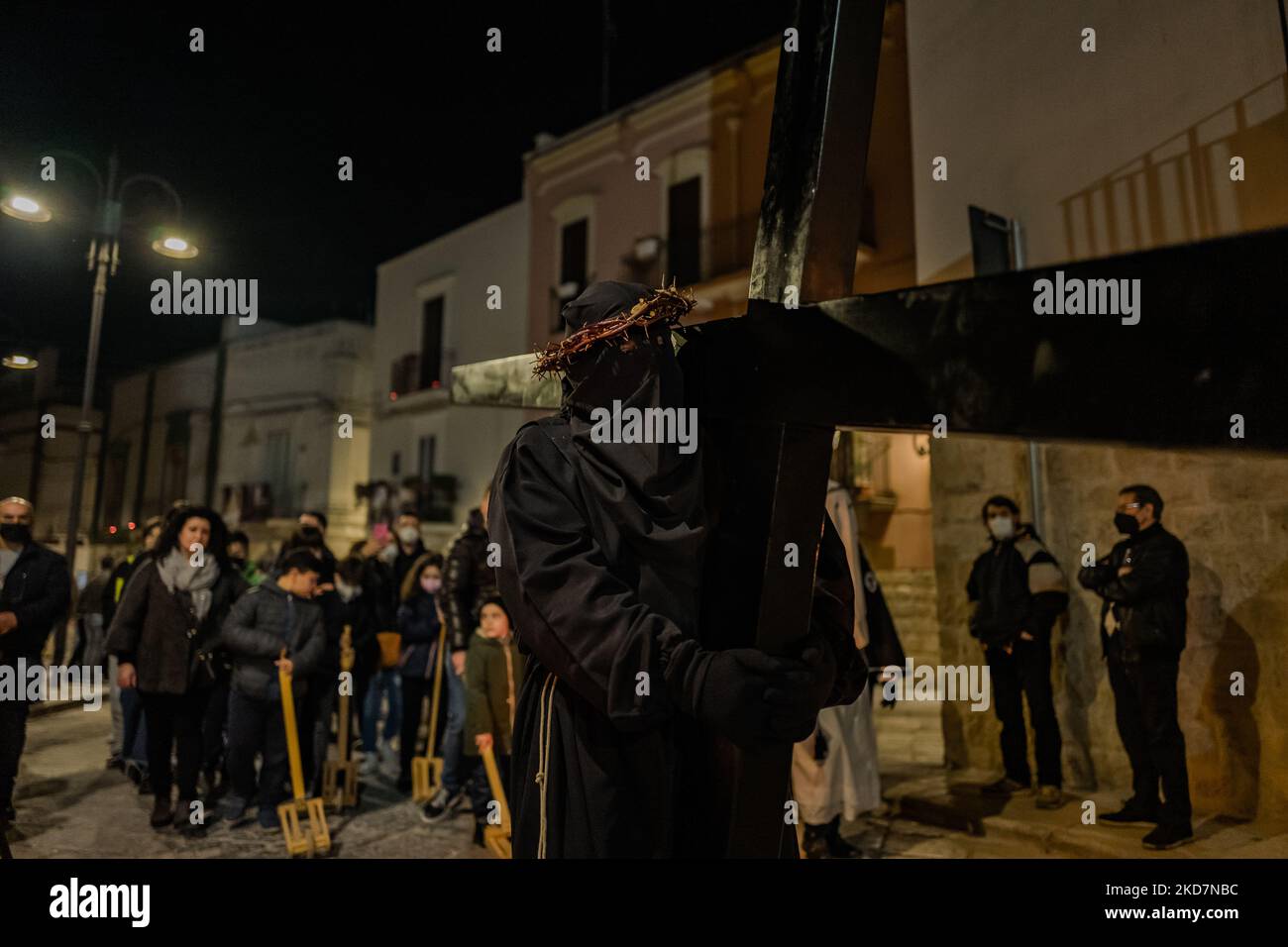 The first crucifer in procession with a heavy cross on his shoulders in ...