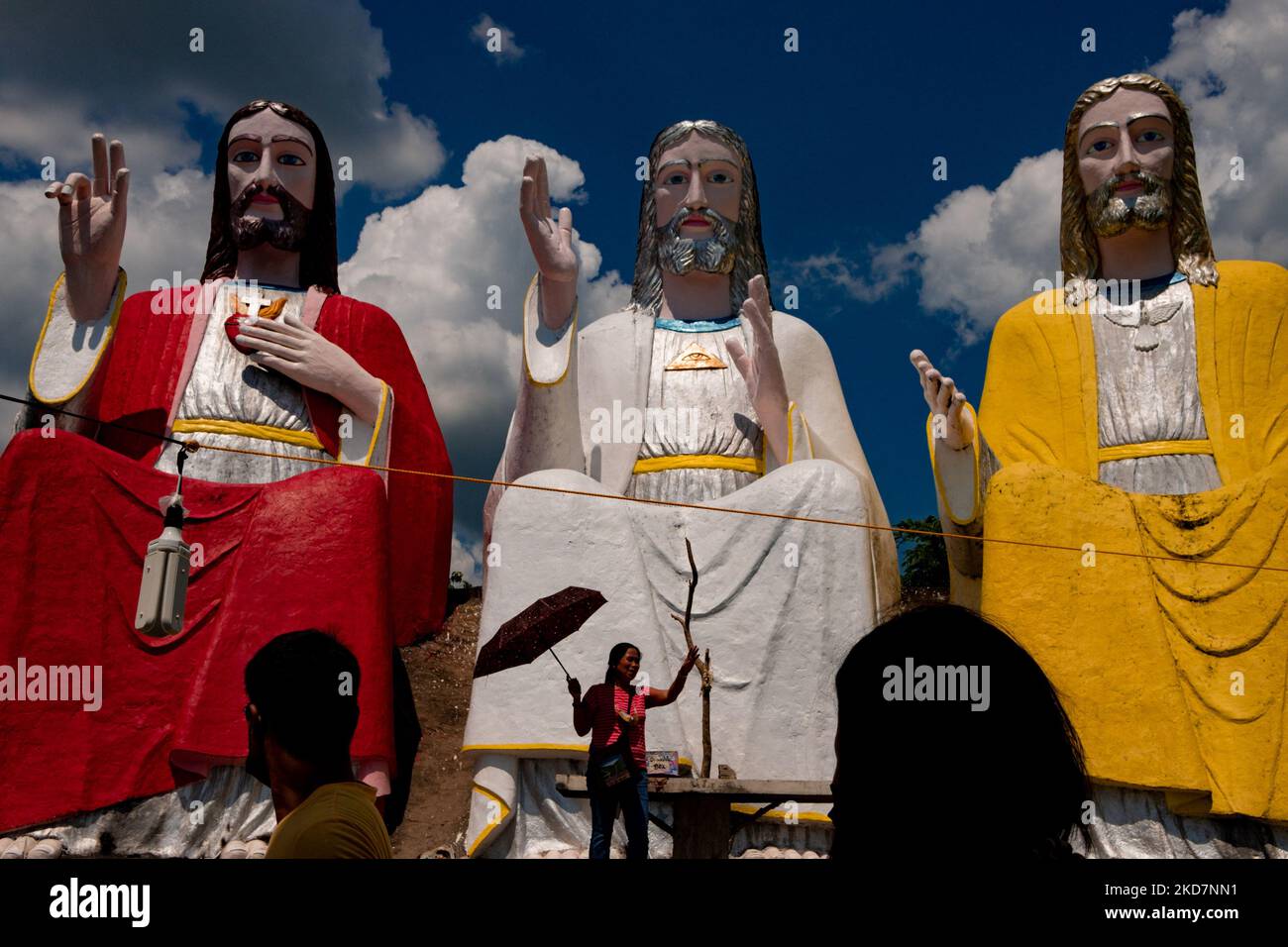 Filipino Catholics visit a hill with giant images of the Holy Trinity ...