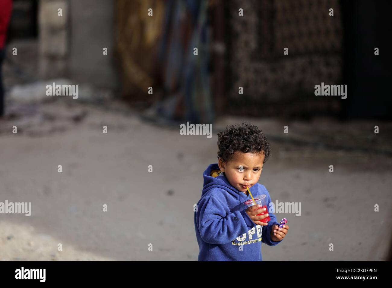 A Palestinian child walks next his house in a poor neighborhood of Gaza ...