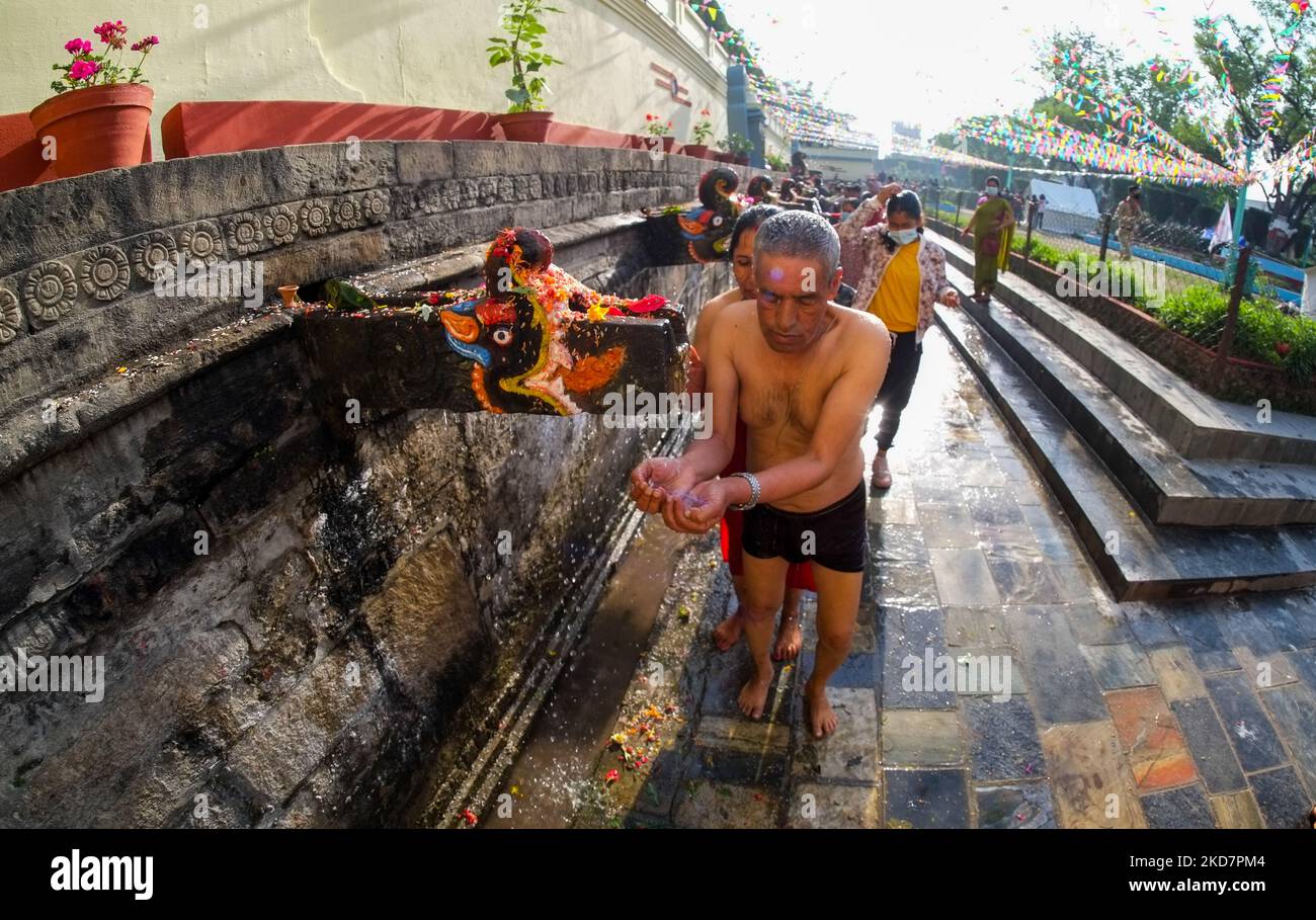 Nepalese devotees take holy baths from 22 stone spouts during Baisdhara ...