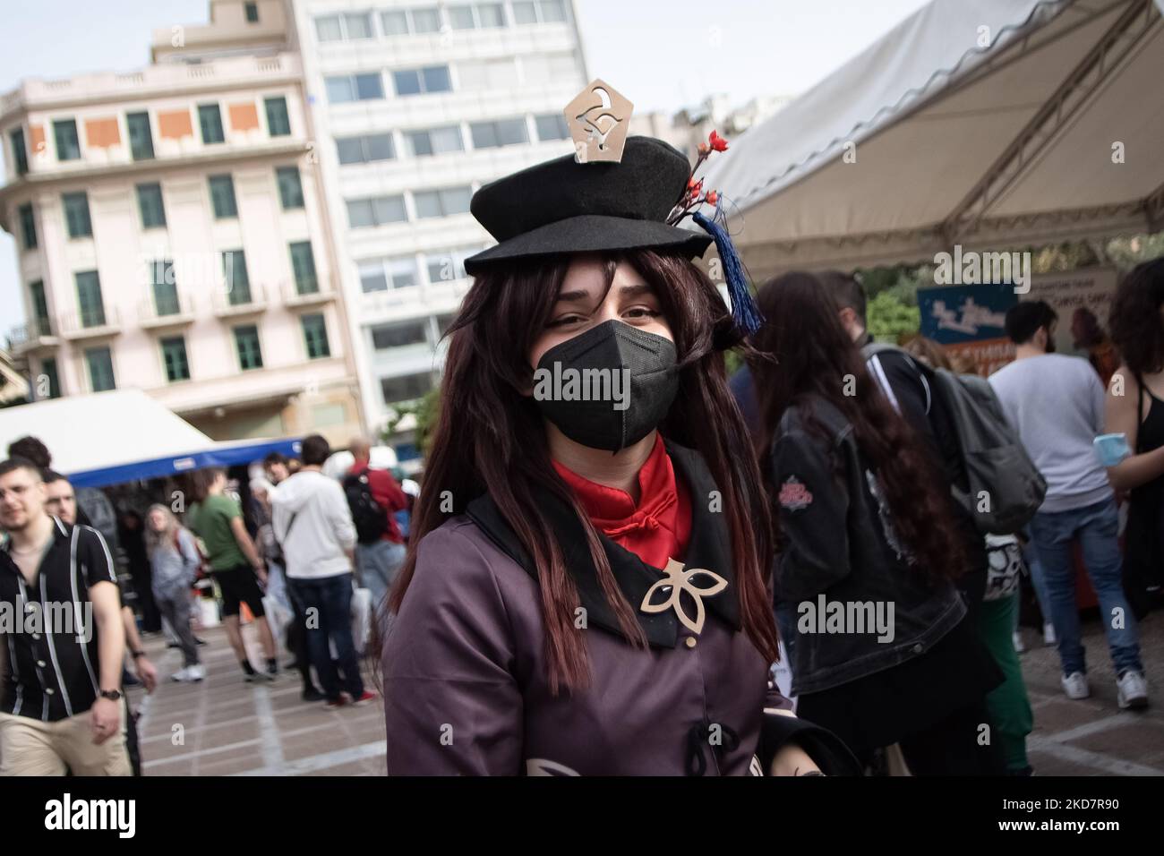 Cosplayers dressed as their favourite characters stand for a photo ...