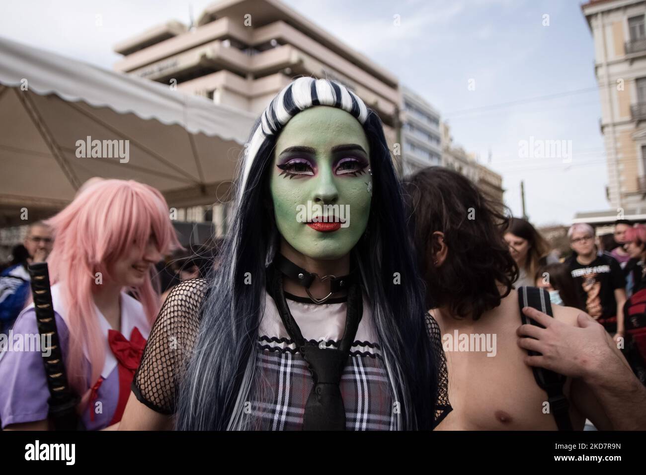 Cosplayers dressed as their favourite characters stand for a photo ...