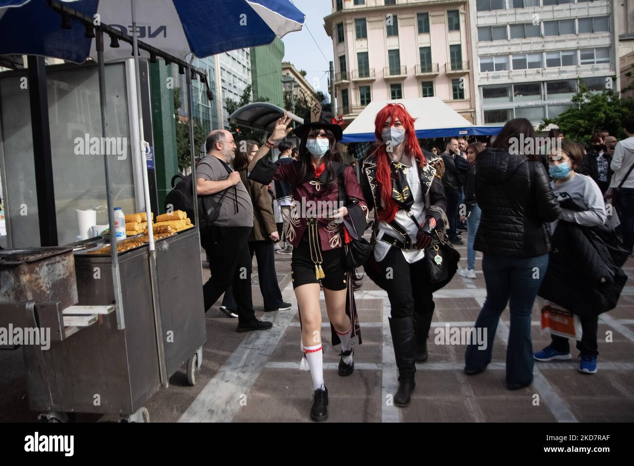 Cosplayers dressed as their favourite characters stand for a photo ...