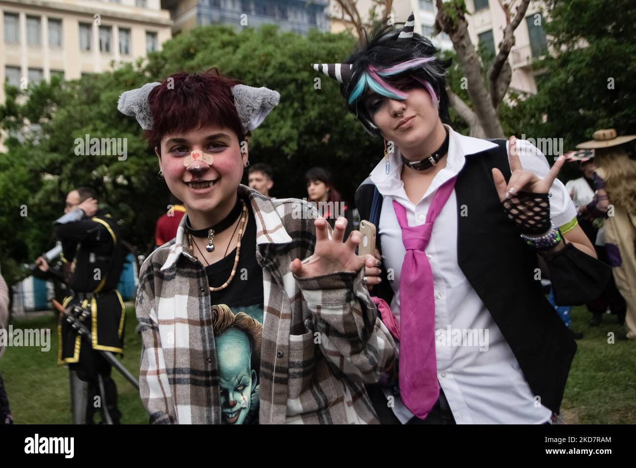 Cosplayers dressed as their favourite characters stand for a photo ...