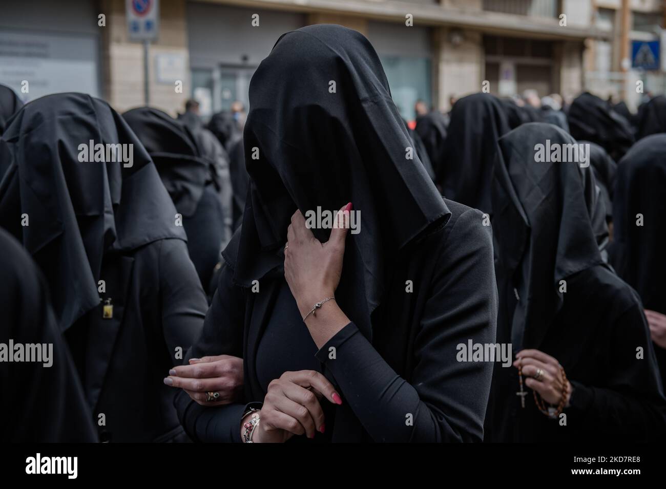 One of the women dressed in black with a covered face on Holy Saturday ...