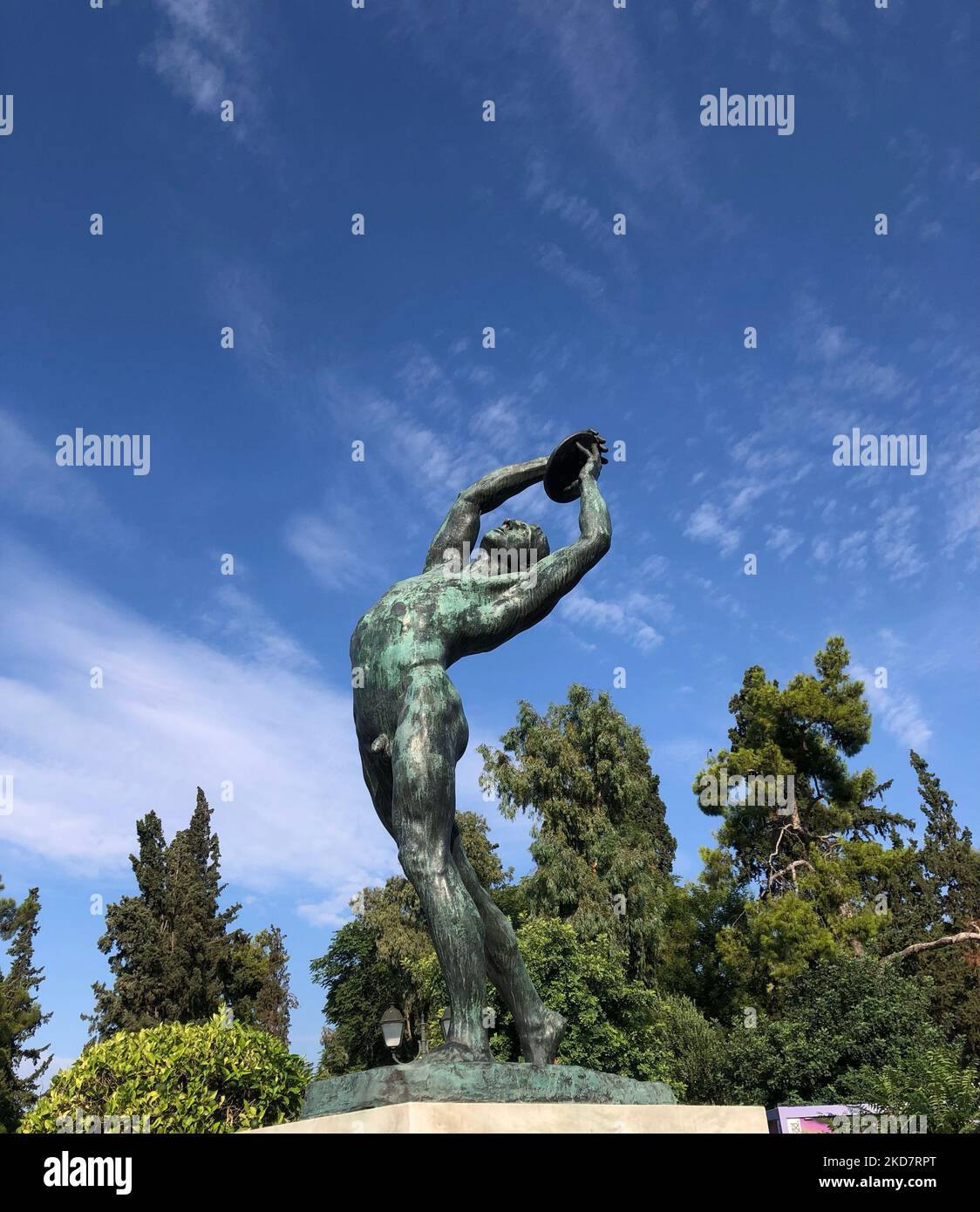 A vertical shot of the statue of Discobolus in front the Panathenaic ...
