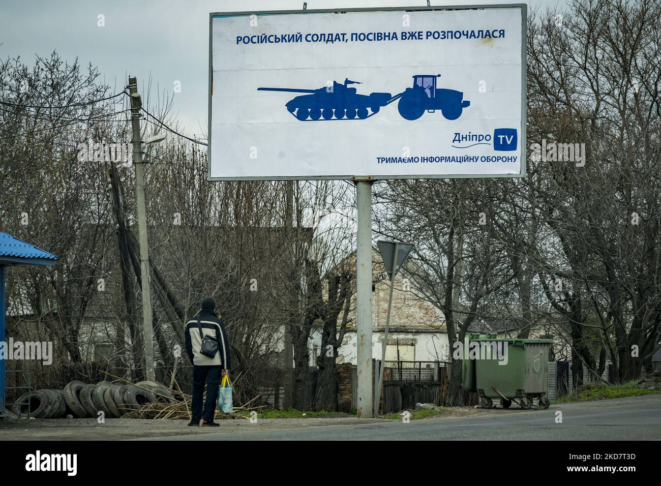 A man looks a ironic banner in Dnipro city saying: "russian soldier ...