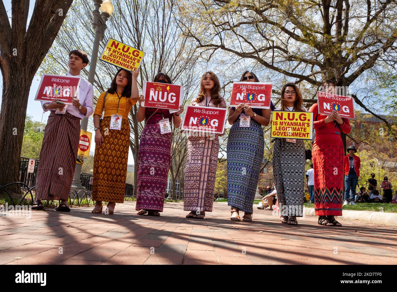 Demonstrators in traditional dress express hold signs supporting ...
