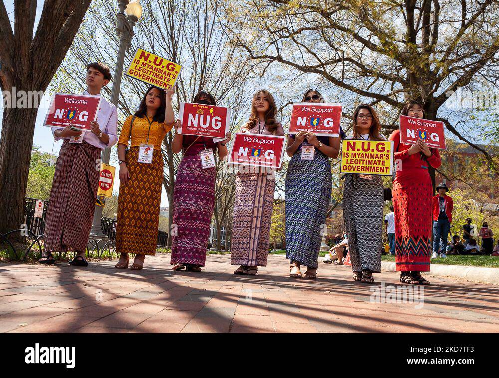 Demonstrators in traditional dress express hold signs supporting ...